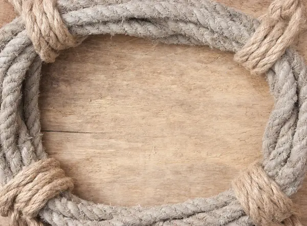 Frame made of twisted rope and old paper on a wooden background ⬇ Stock ...