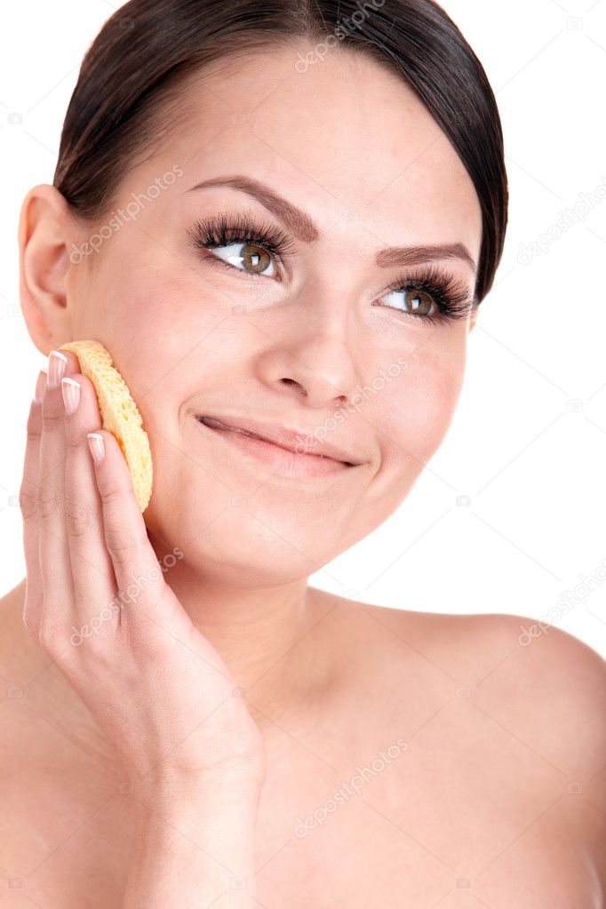 Young woman washing her face by sponge. — Stock Photo © poznyakov #5736901
