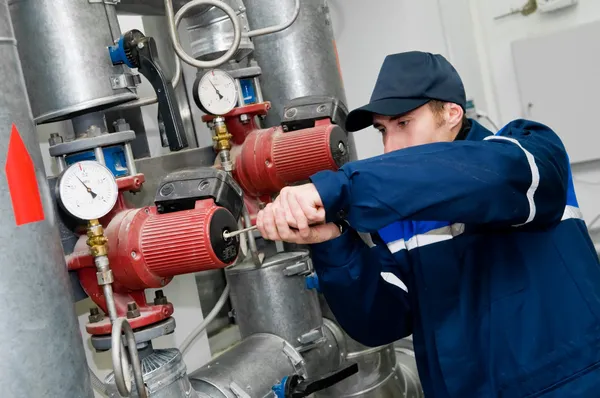 Heating engineer in boiler room - Stock Image - Everypixel