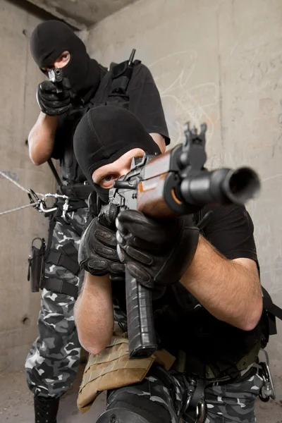 Soldiers in black masks with weapons - Stock Image - Everypixel