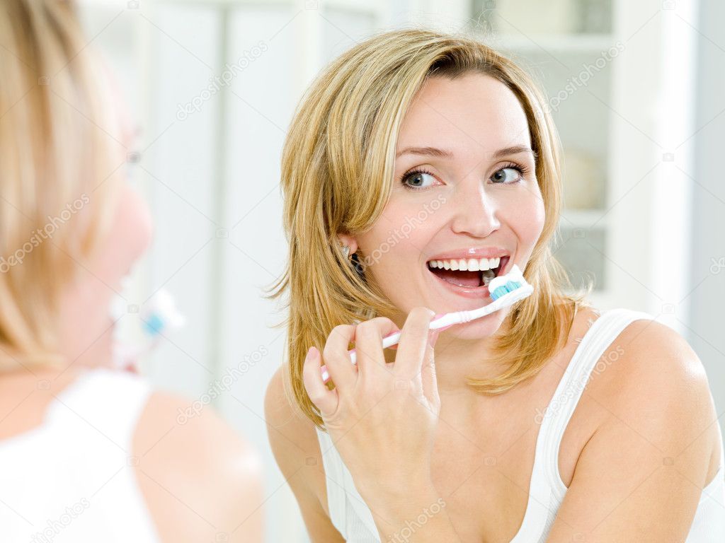 Happy woman cleaning teeth with toothbrush — Stock Photo © valuavitaly ...