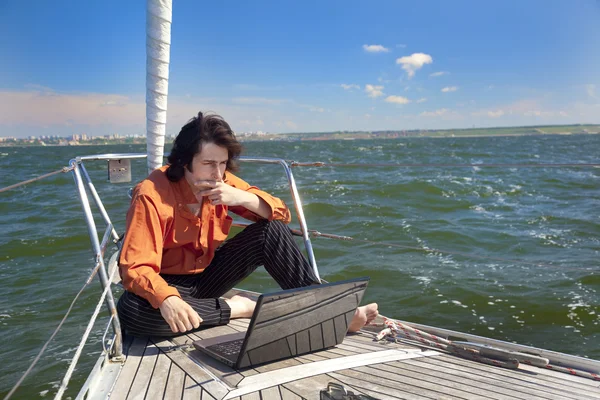 Businessman with laptop on sailboat - Stock Image - Everypixel