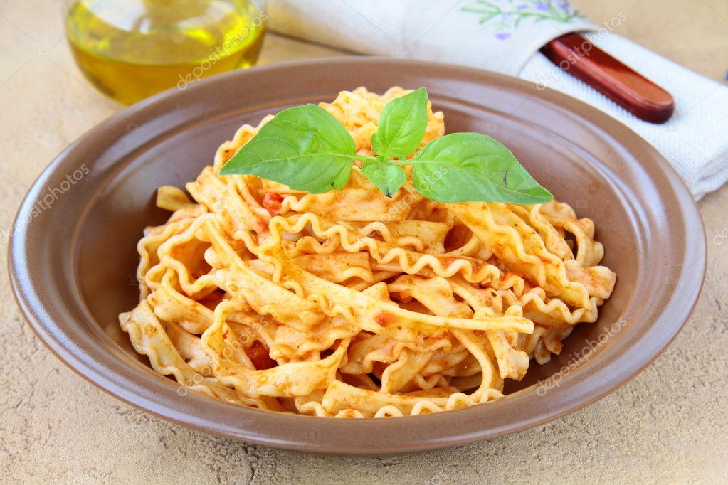 Italian pasta tripoline with tomato sauce and basil — Stock Photo ...