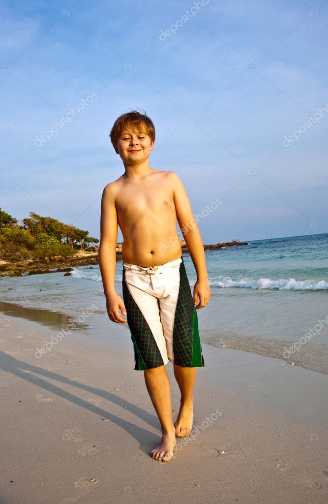 Happy smiling young boy with background blue sky irises up his a ...
