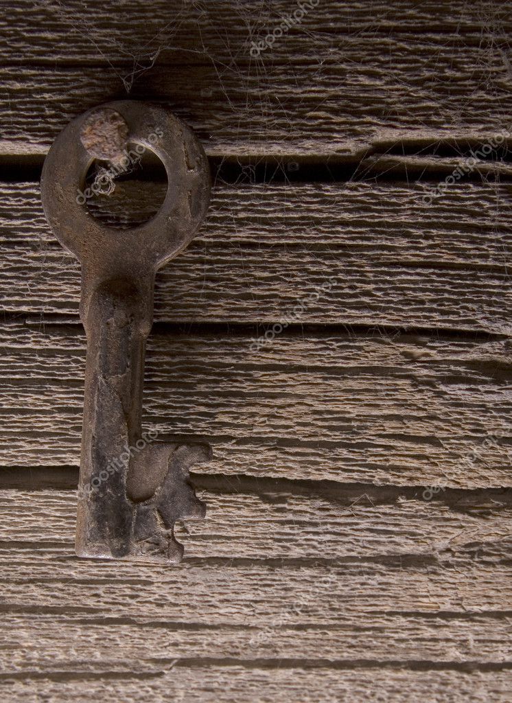 Old key on wood deck Stock Photo by ©chepko 5645360