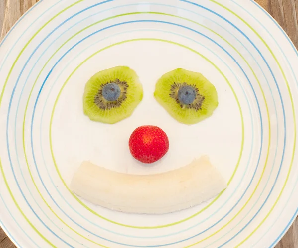 Fruity face clown on a plate - Stock Image - Everypixel