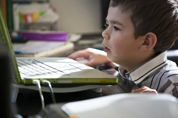 Young boy working on computer. Stock Photo by ©gregepperson 5903786
