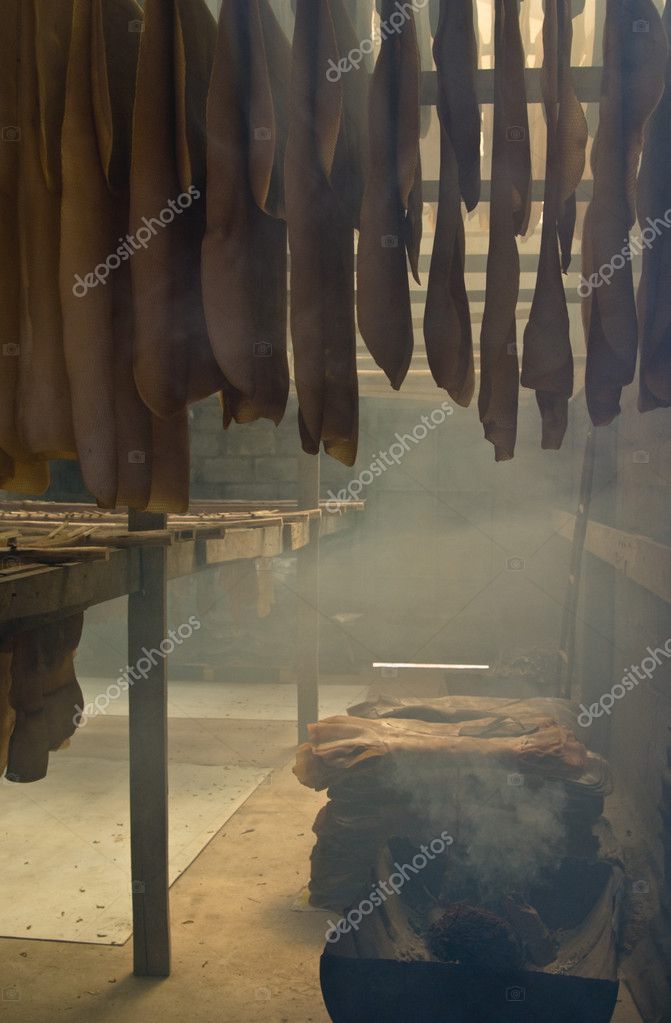 Hot-drying natural rubber in a smokehouse — Stock Photo © Rhombur #5841645