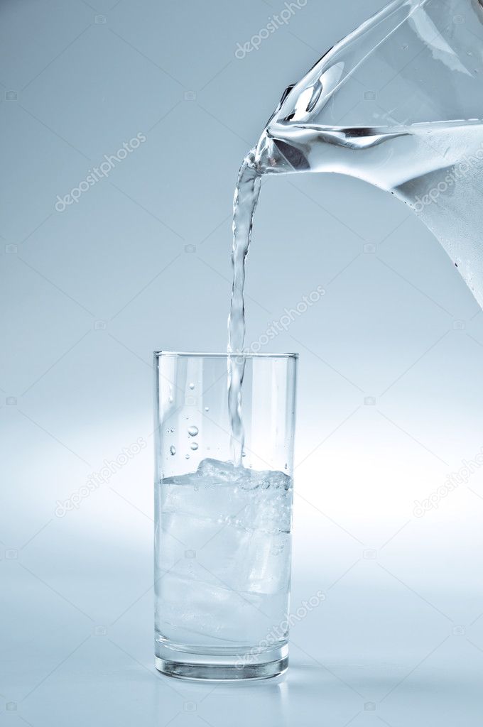 Water being poured from the pitcher to the glass — Stock Photo ...