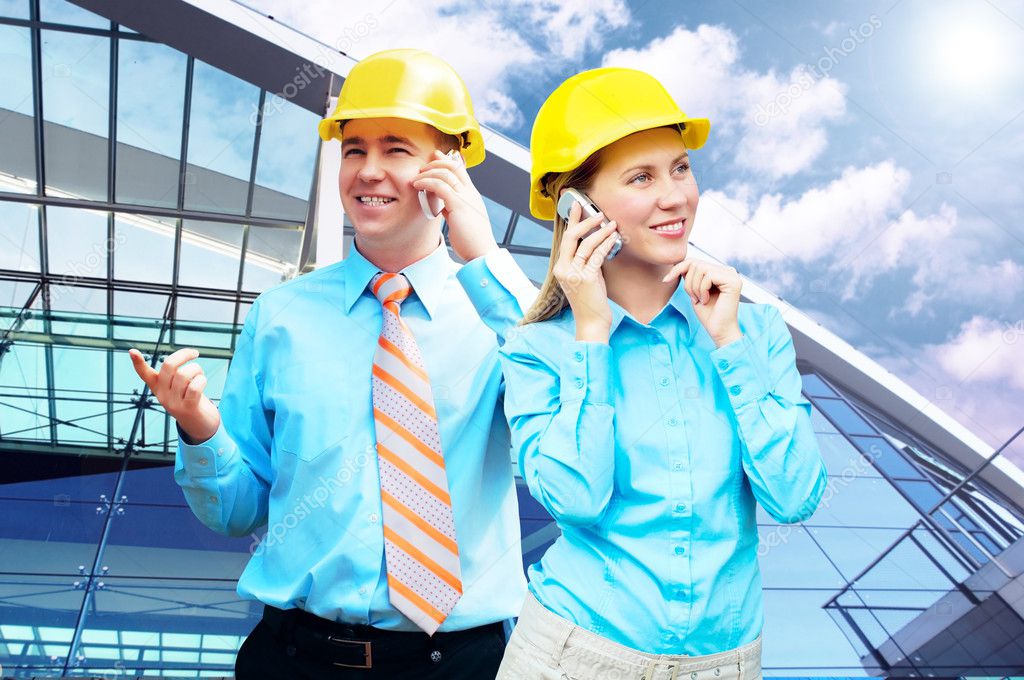Young architects wearing a protective helmet standing on the bui ...