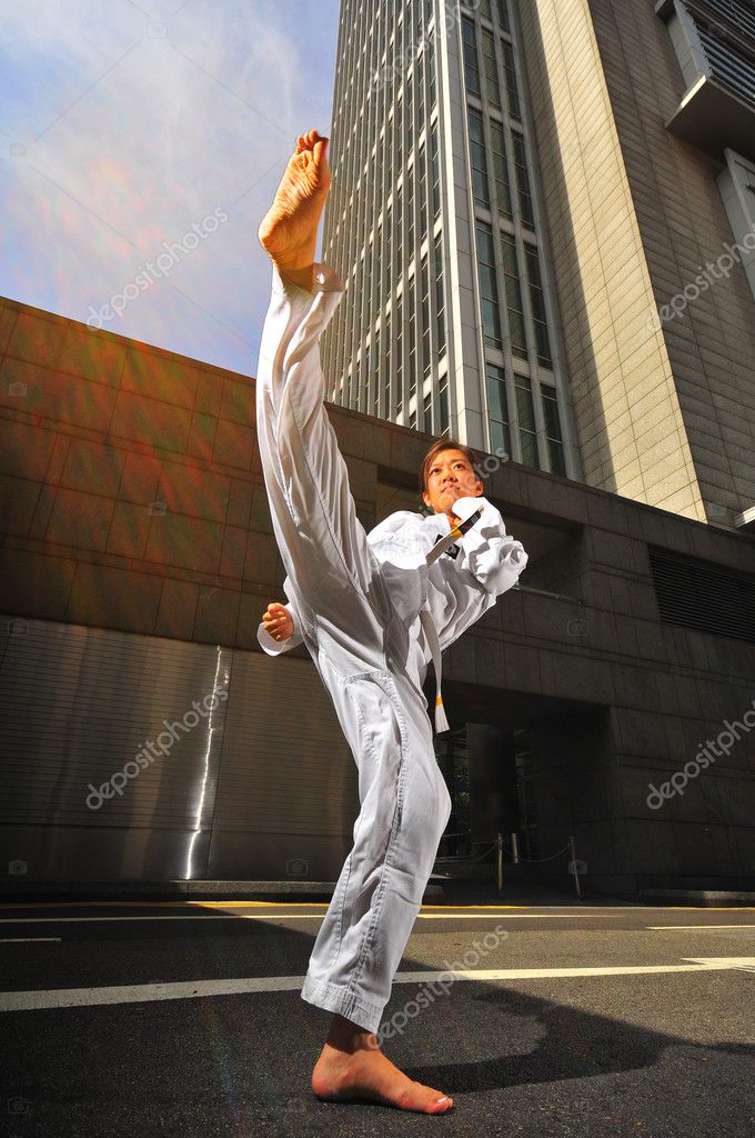 Asian chinese lady in karate gear in the city district — Stock Photo ...