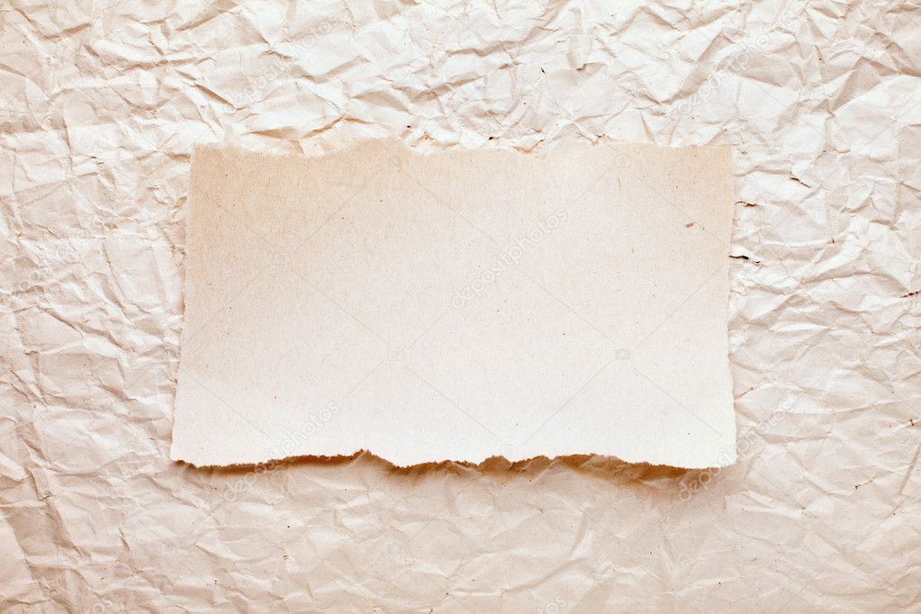 Ripped piece of paper on old crushed paper background. vintage r ...