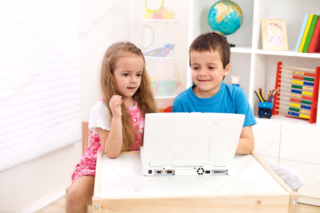 Two kids looking at laptop computer — Stock Photo © ilona75 #6430373