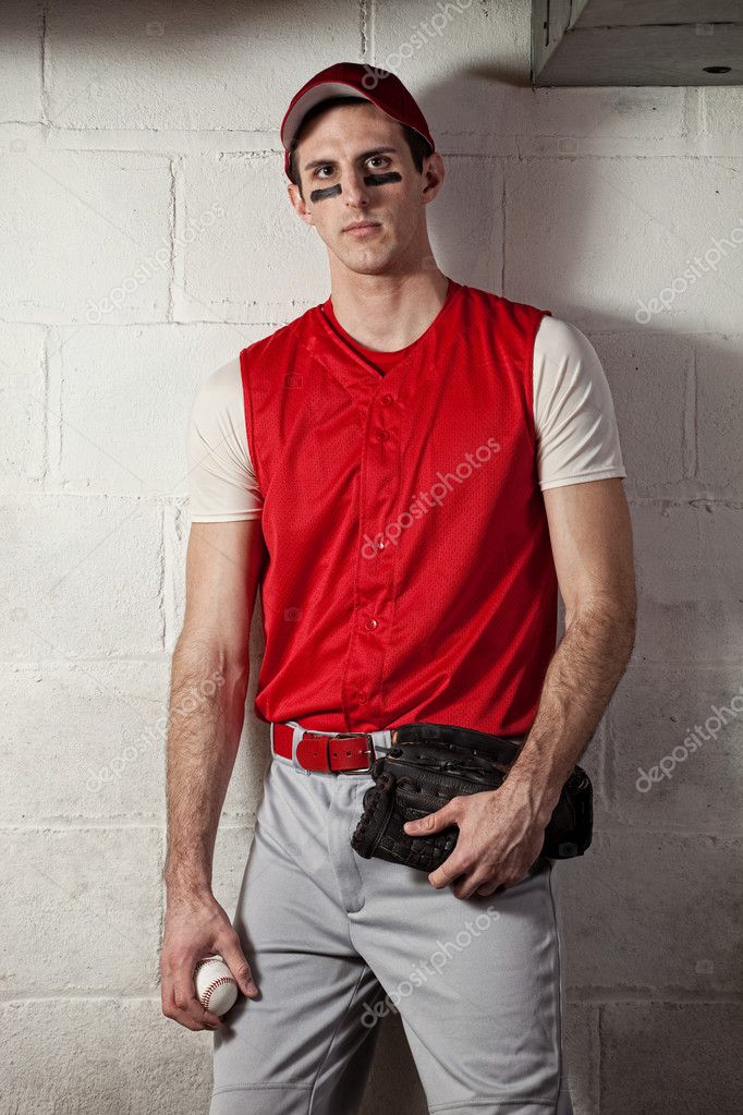 Baseball player in front of concrete block wall. Stock Photo by ...