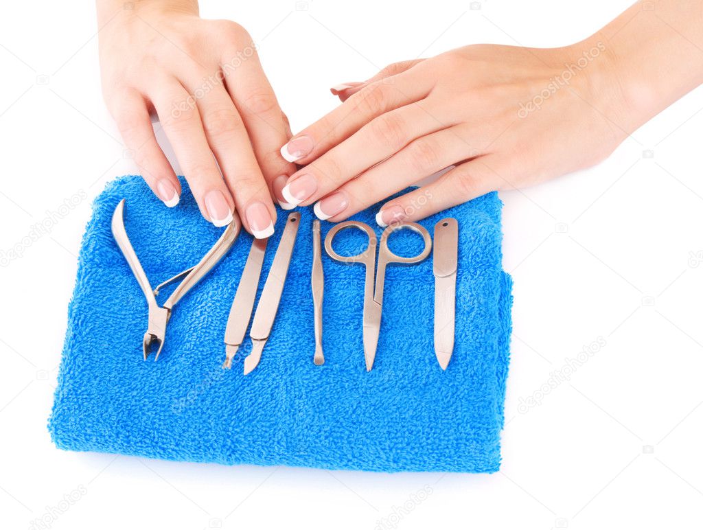 Womans hands and manicure instruments on blue background — Stock Photo ...