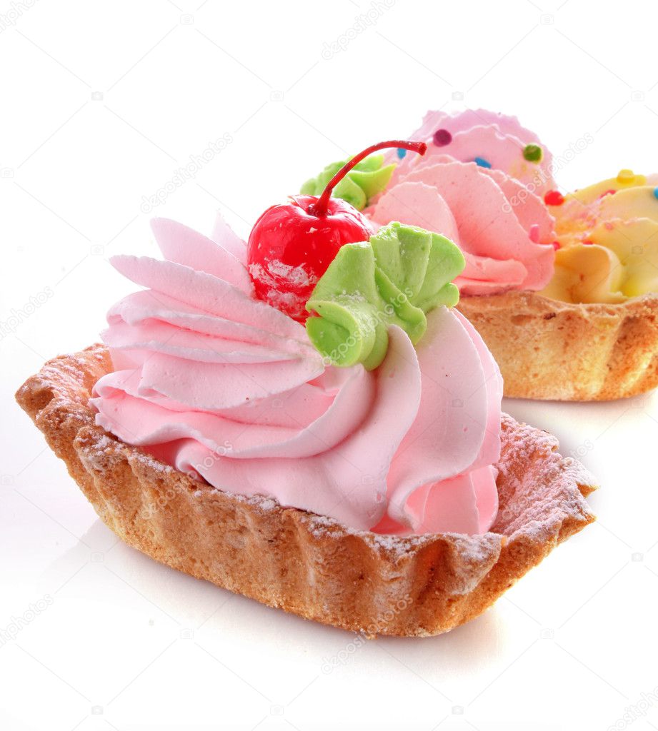 Pink cheesecake with maraschino cherry on white Stock Photo by ...